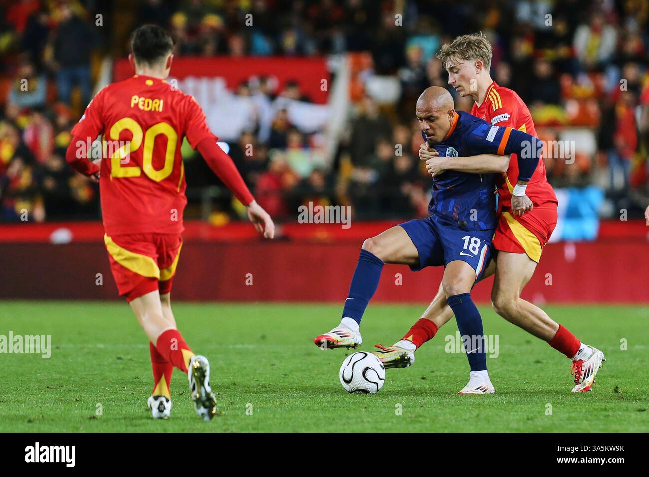 Spain's Dean Huijsen, right, duels for the ball with Netherlands ...