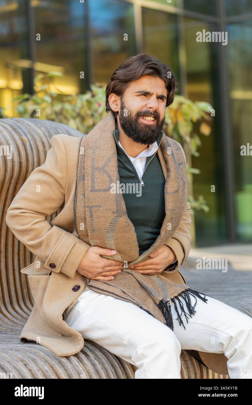 Indian Arabian business man feeling sudden strong abdominal stomach ...