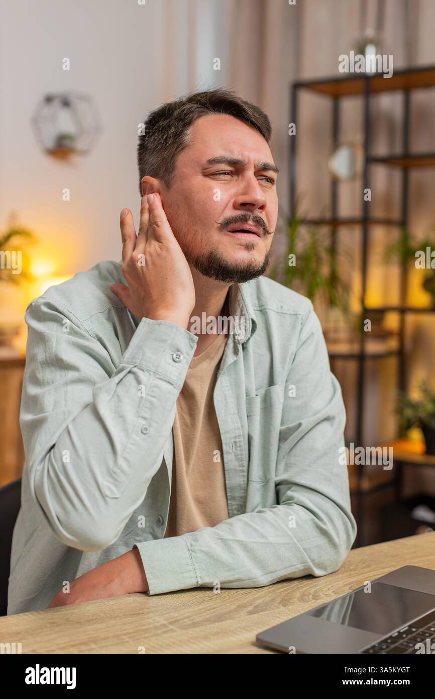 Sick young Caucasian man freelancer sitting at home office table ...