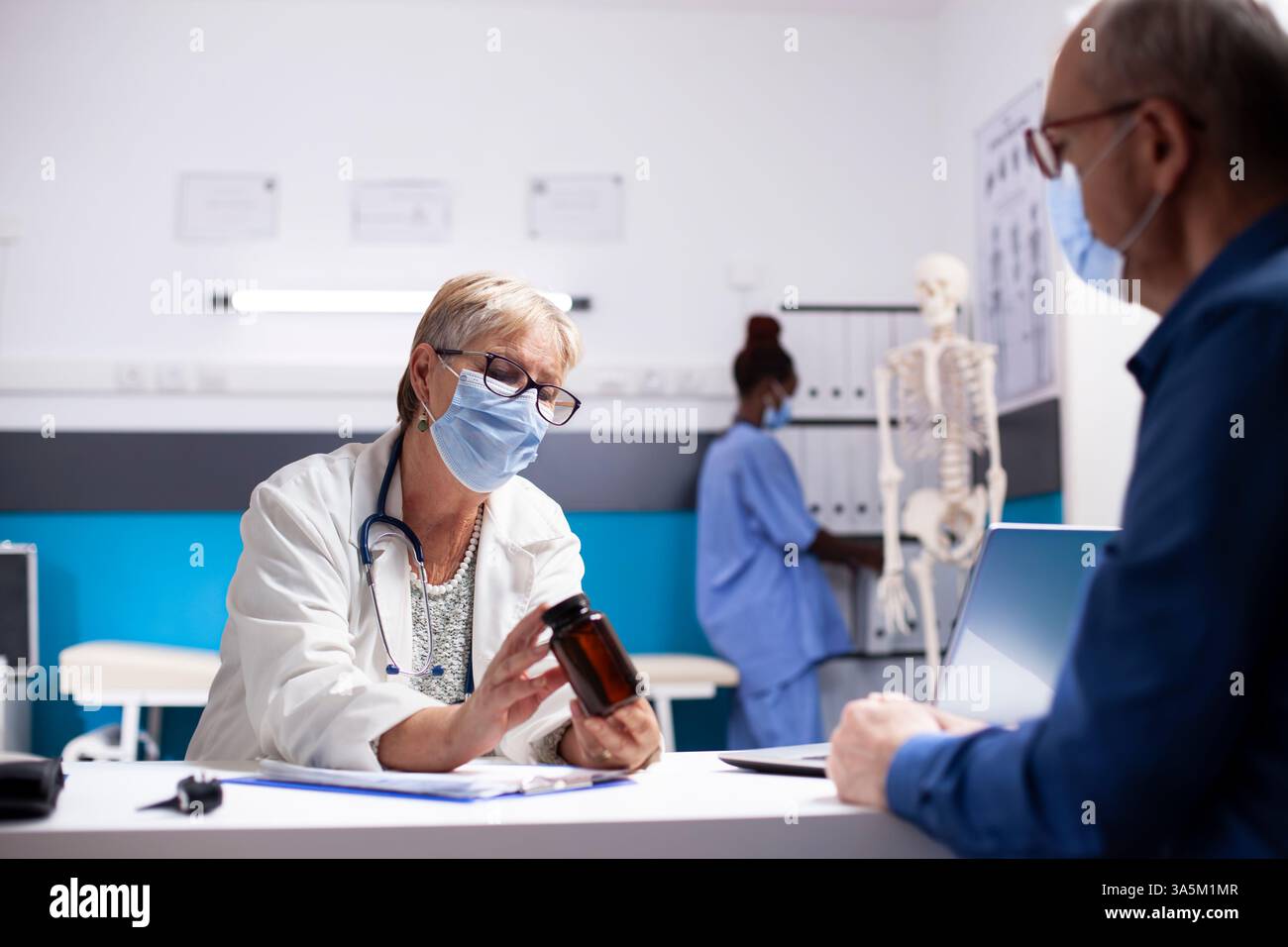 In clinic, elderly doctor discusses treatment plan with retired male ...