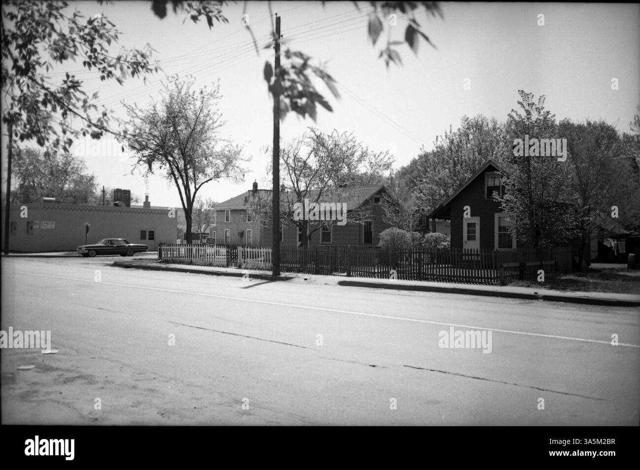 A photograph of houses on 25th Street East taken in May 1965, capturing ...