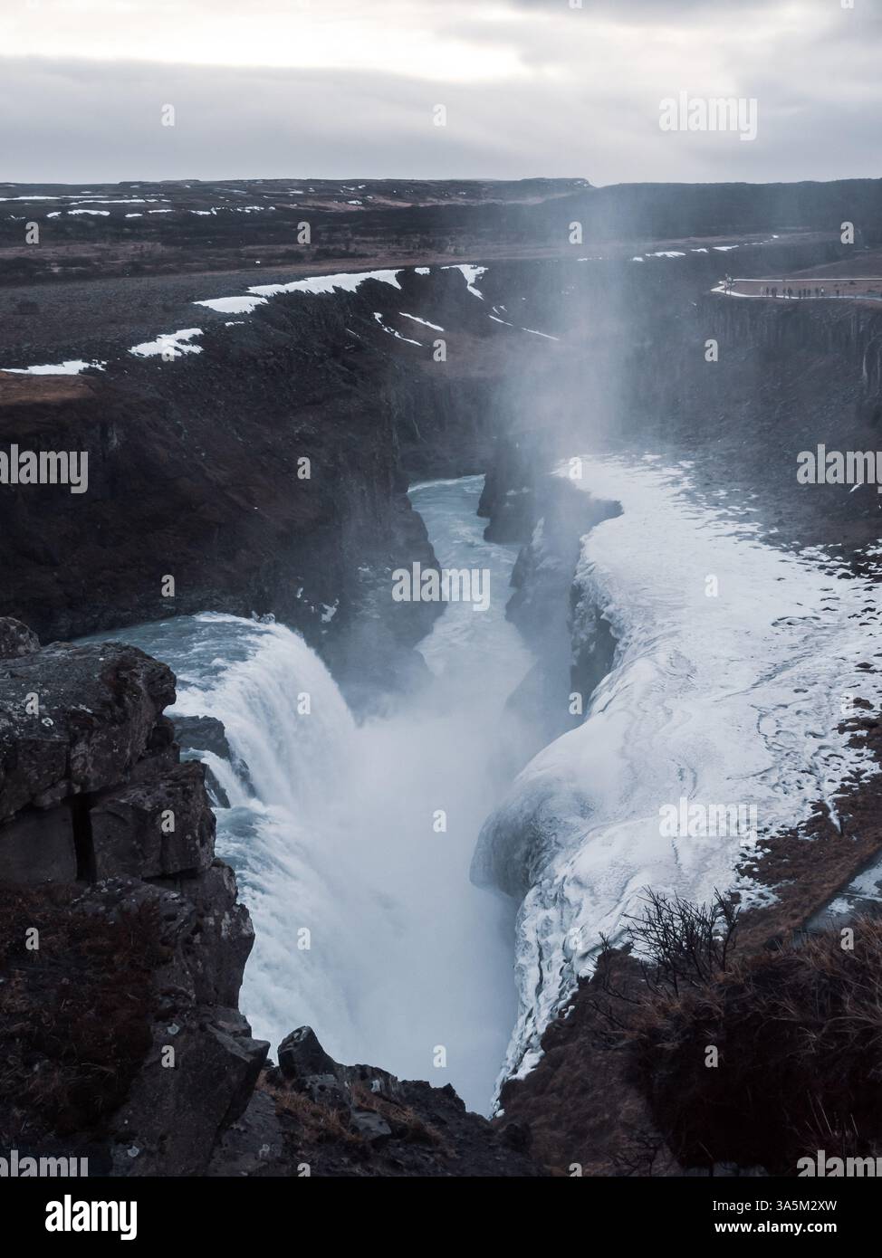 Gullfoss waterfall in Iceland, with mist rising from the powerful ...