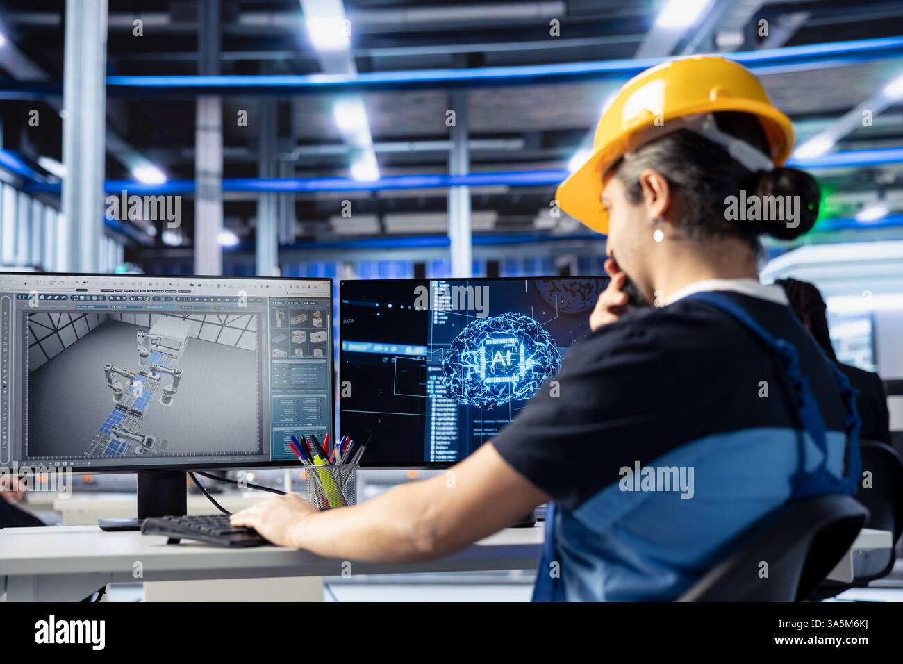 Photovoltaic facility system administrator developing AI tool in factory to predict equipment ...