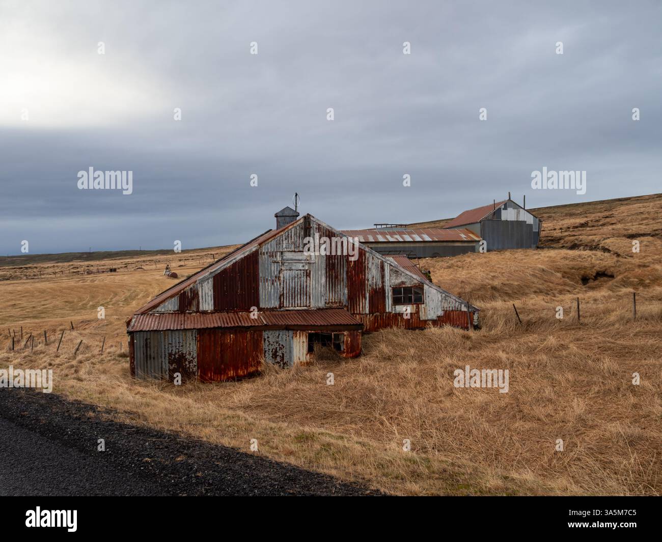 An abandoned Icelandic farmhouse with rusted metal walls and a ...