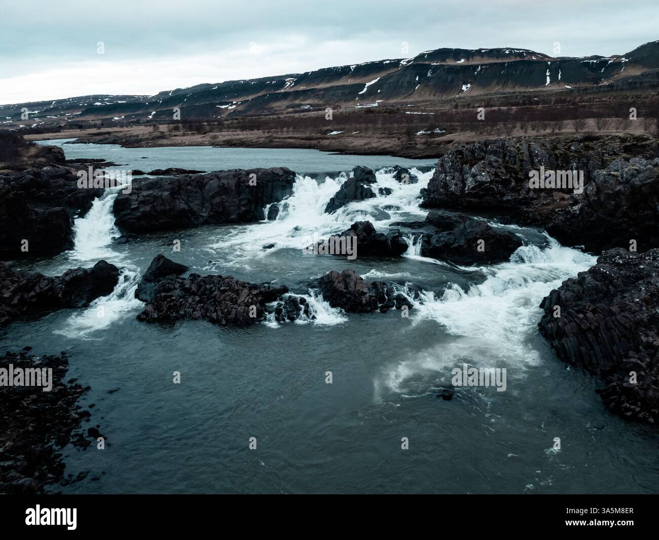 Glanni waterfall, a hidden gem in Iceland, cascades over rugged ...