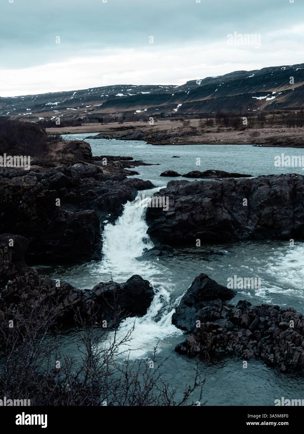 Glanni waterfall, a hidden gem in Iceland, cascades over rugged ...