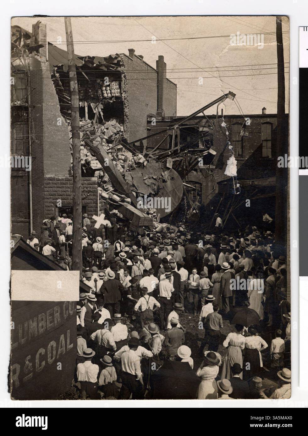 Spectators view the aftermath of a cave-in at the Patterson Warehouse ...