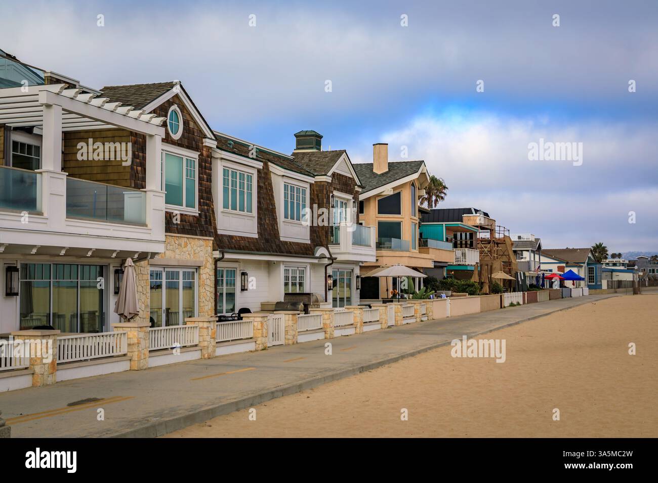 Beachfront homes of diverse architecture line the sandy shore at the ...