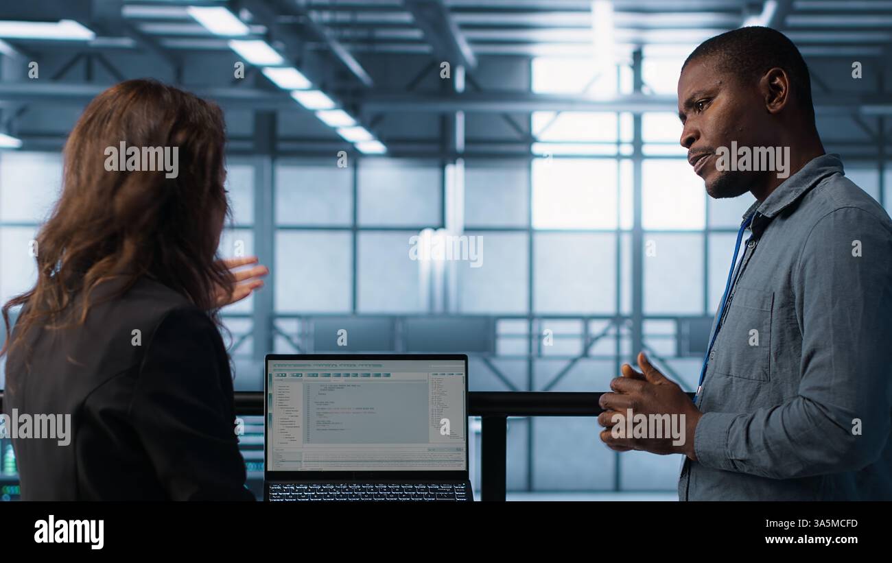 Teamworking data center computer scientists using artificial intelligence on laptop and tablet ...