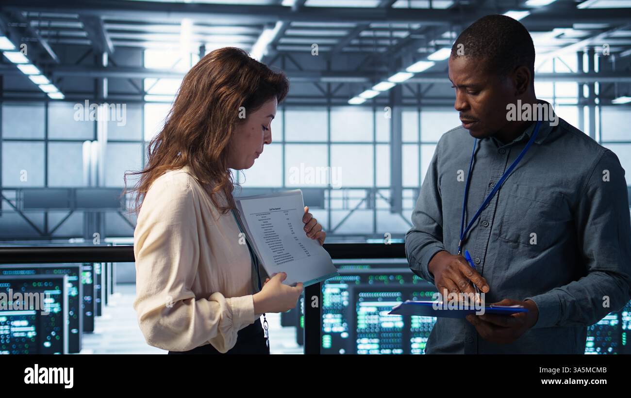 Team of IT professionals looking over data center checkup checklist ...