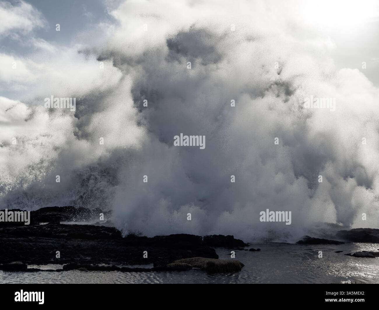 A gigantic wave explodes into mist on Iceland’s coast, forming a ...