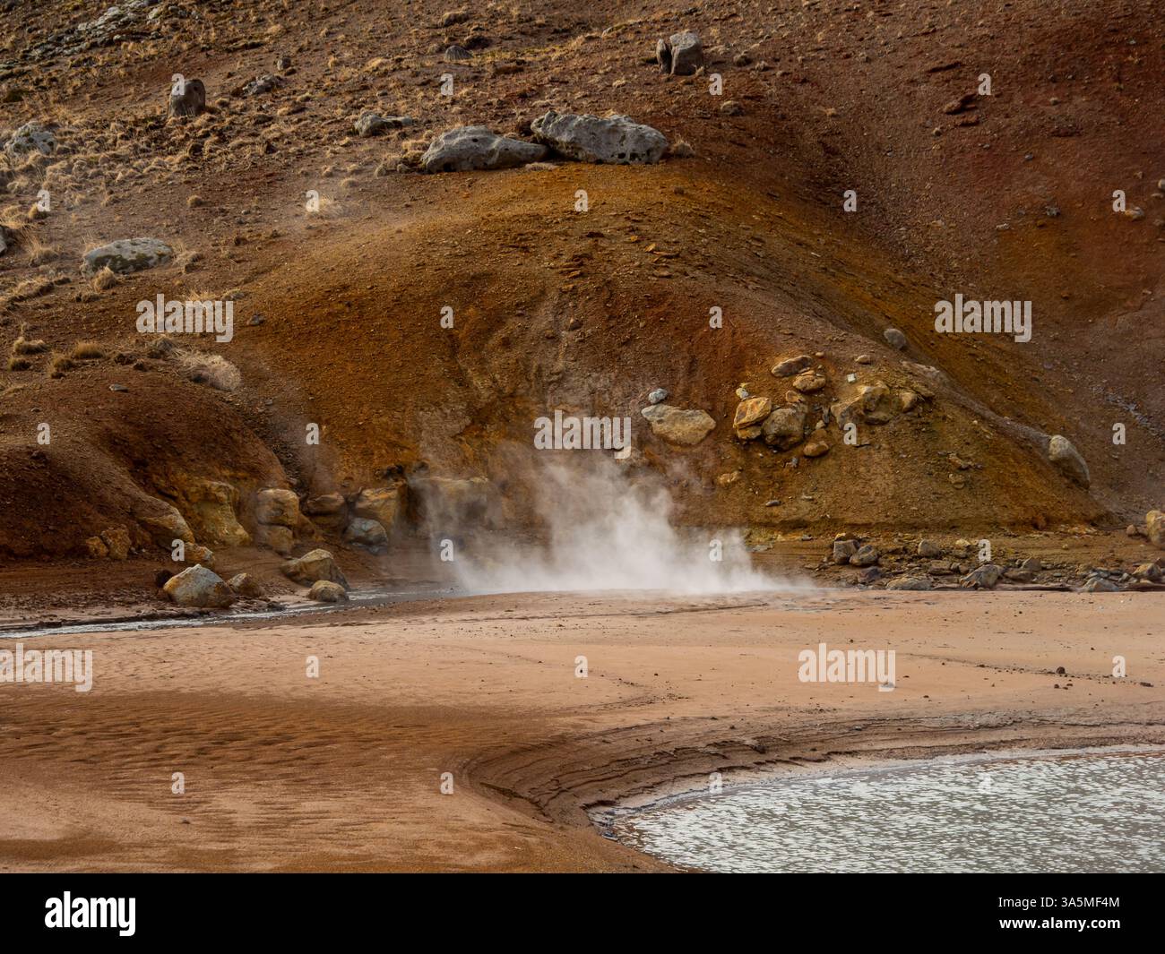 Steam rises from a bubbling geothermal vent in the Krýsuvík area of ...