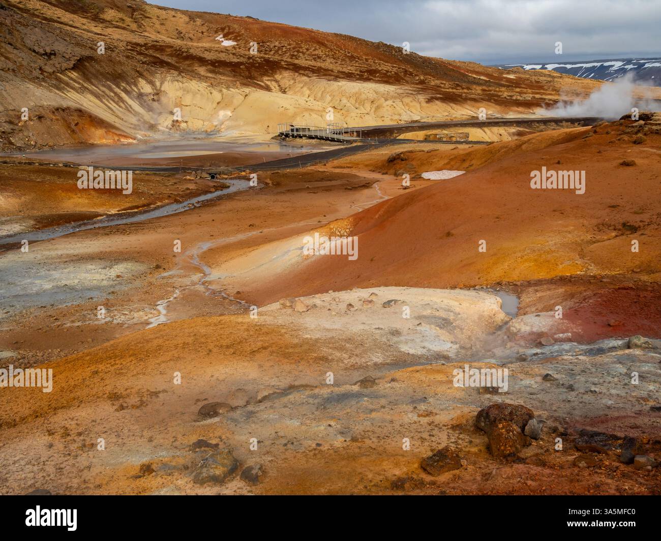 A vivid geothermal landscape at Seltún with steaming vents, colorful ...