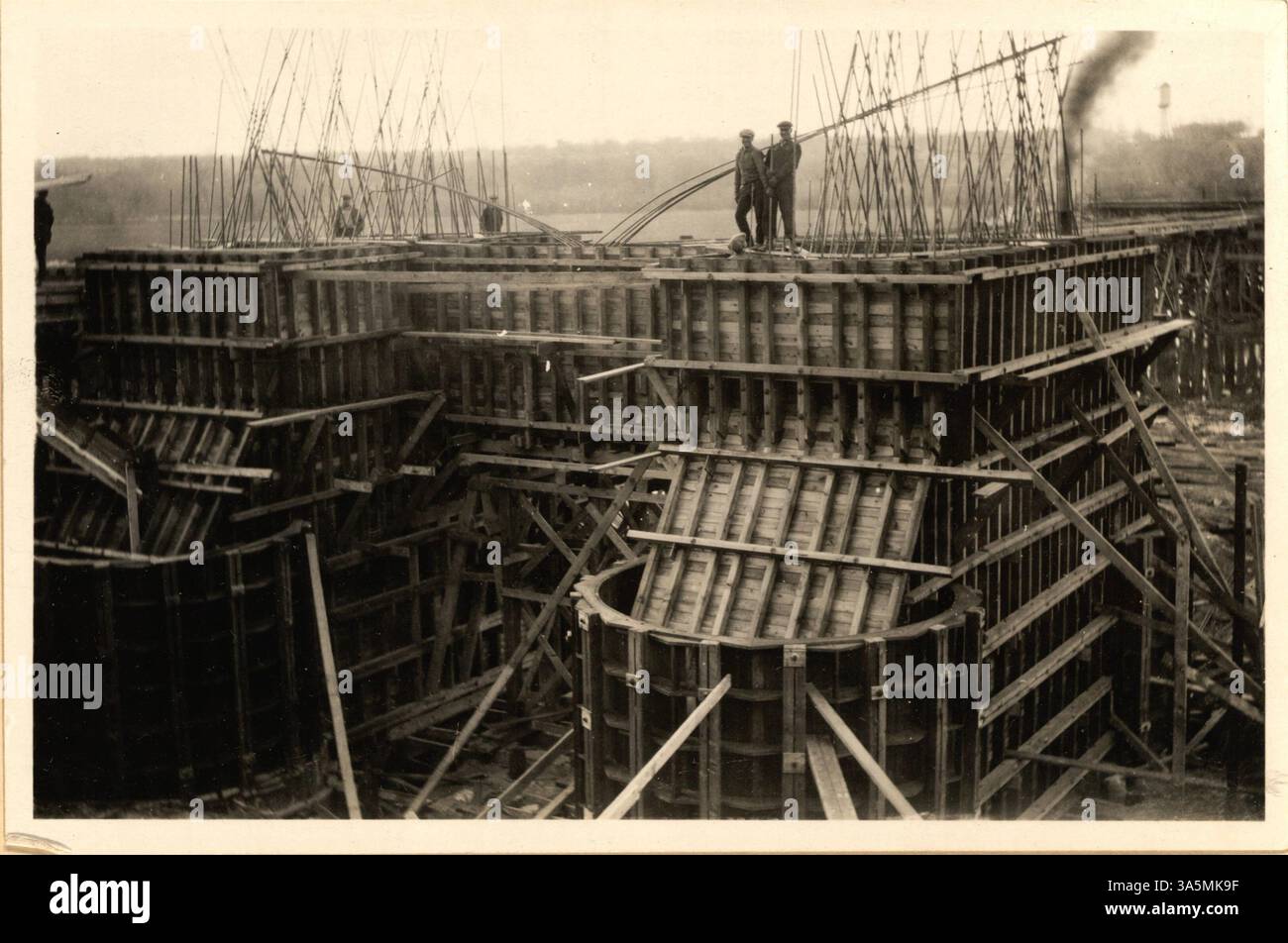 This photo captures workers constructing one of the concrete piers for ...
