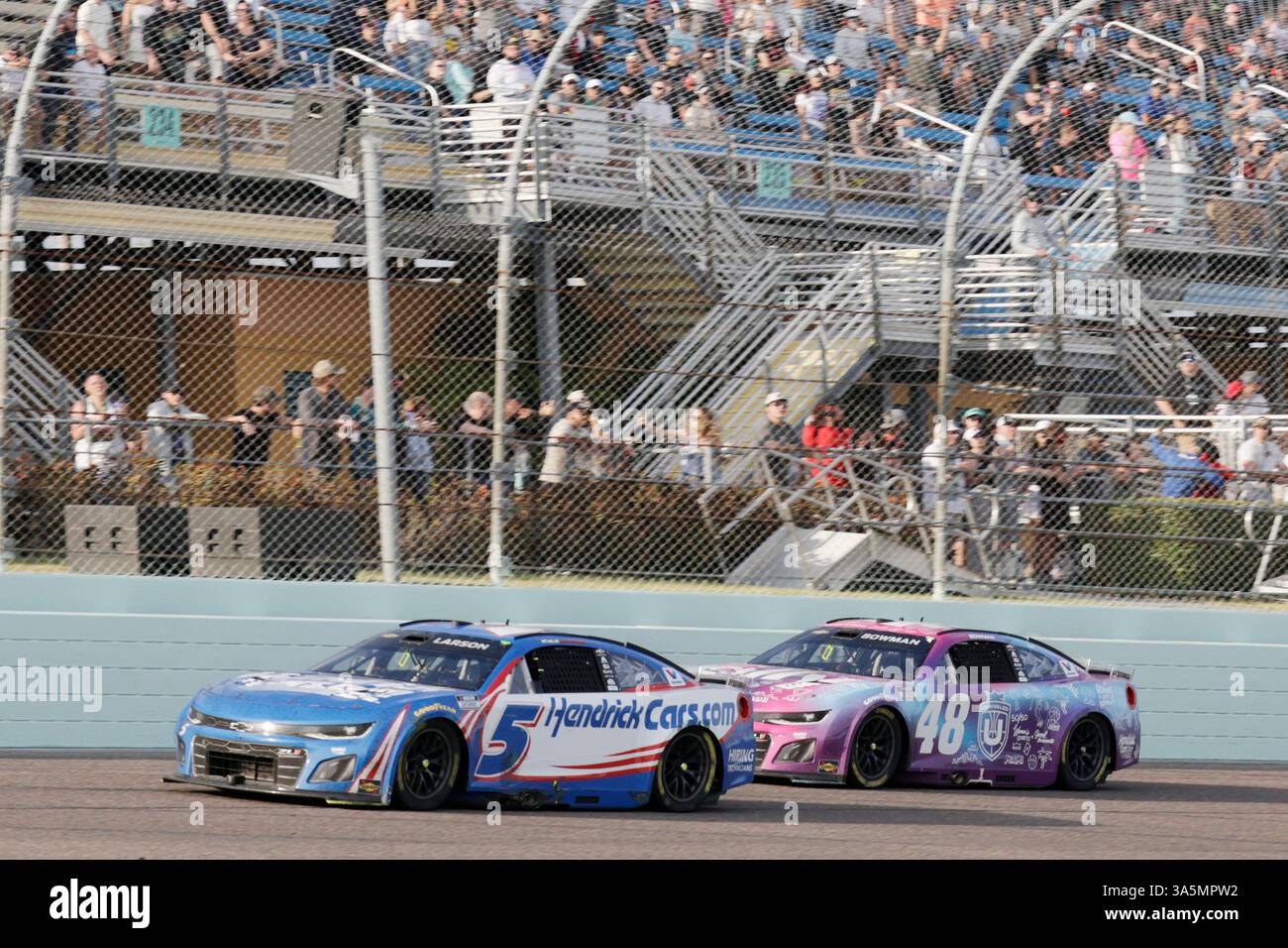 Kyle Larson (5) passes Bubba Wallace (23) to take the lead during a ...