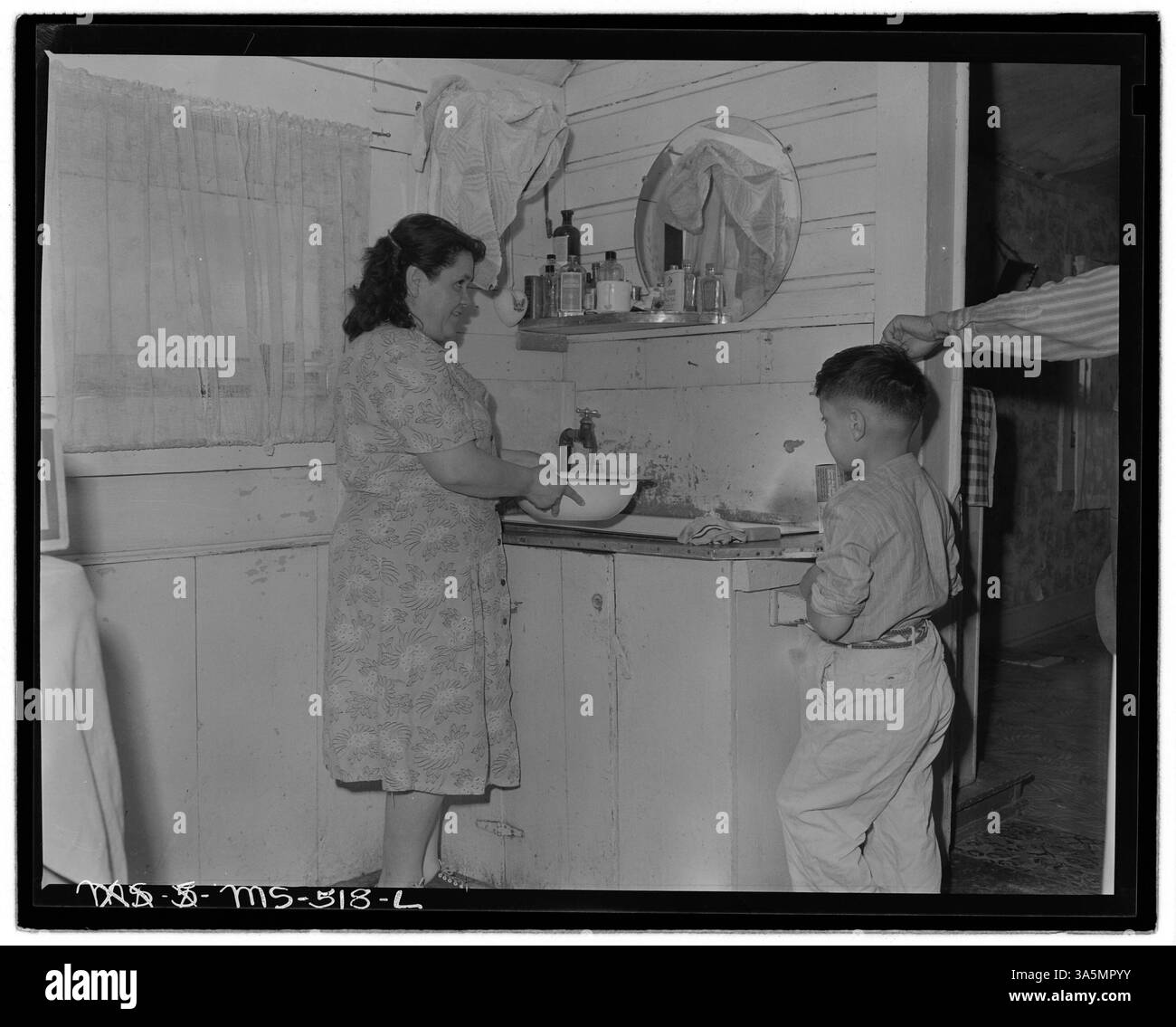 Mrs. Manuel Alcala and her son are in their kitchen in a company ...