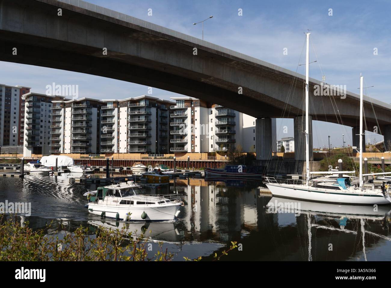 Boats on the River Ely in Cardiff Bay Wales, with modern waterside ...