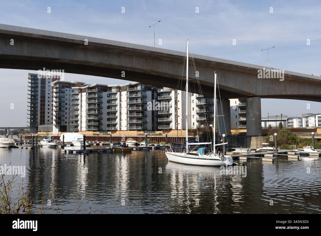Boats on the River Ely in Cardiff Bay Wales, with modern waterside ...