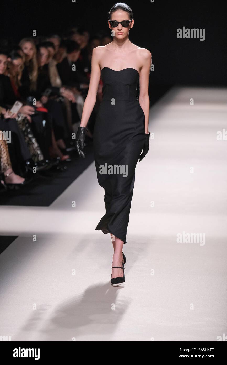 A model walks the runway wearing a design by Alex Riviere during ...