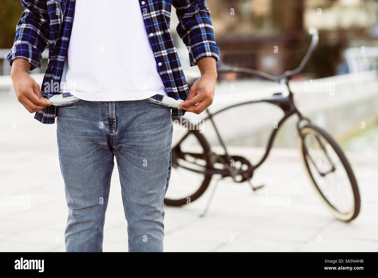 African guy showing his empty pockets outdoors Stock Photo - Alamy