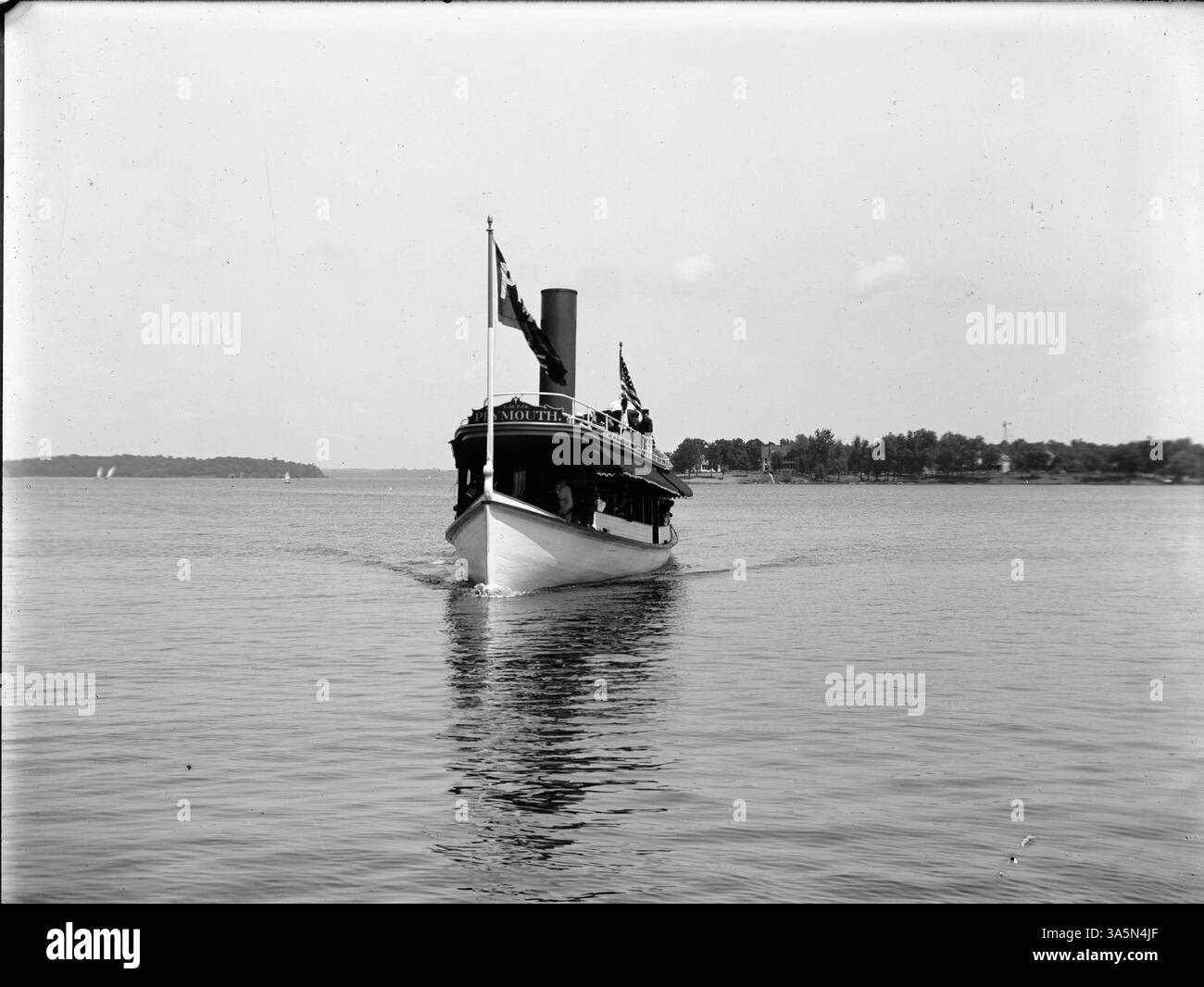 The steam launch 'Plymouth' is seen navigating near Big Island on Lake ...
