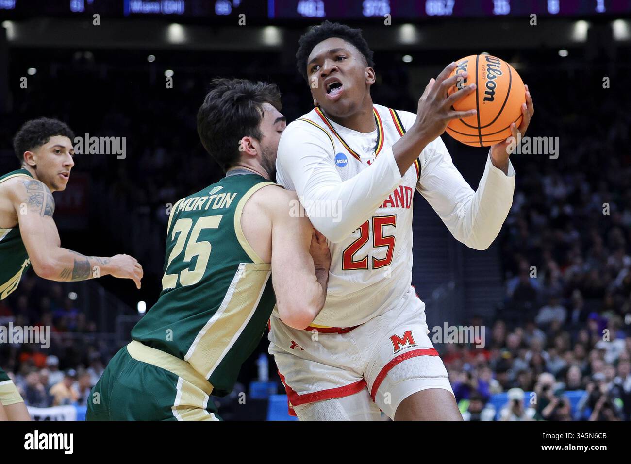 Maryland center Derik Queen, right, drives against Colorado State guard ...