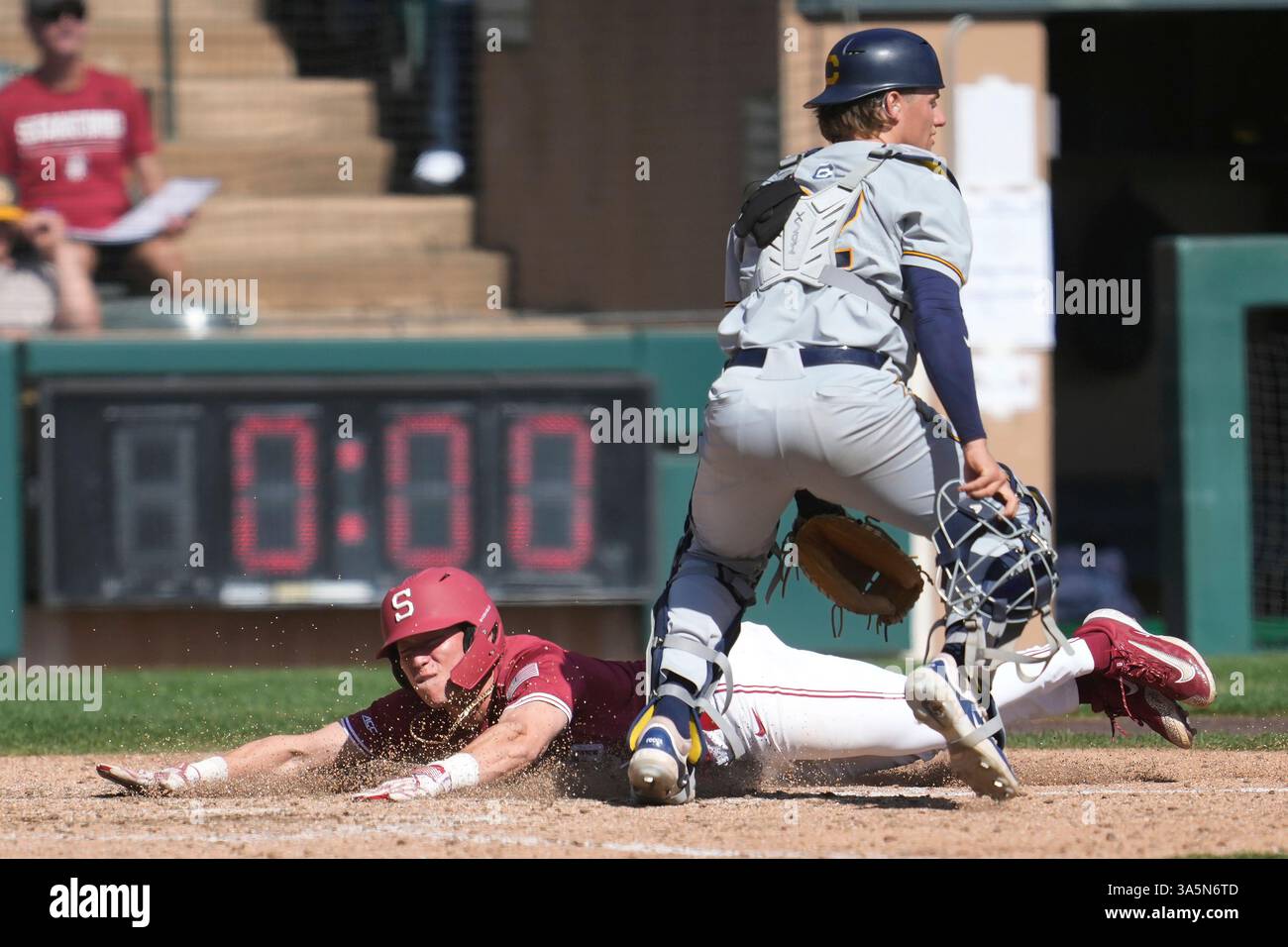 Stanford's Trevor Haskins, bottom, scores past California catcher Alex ...