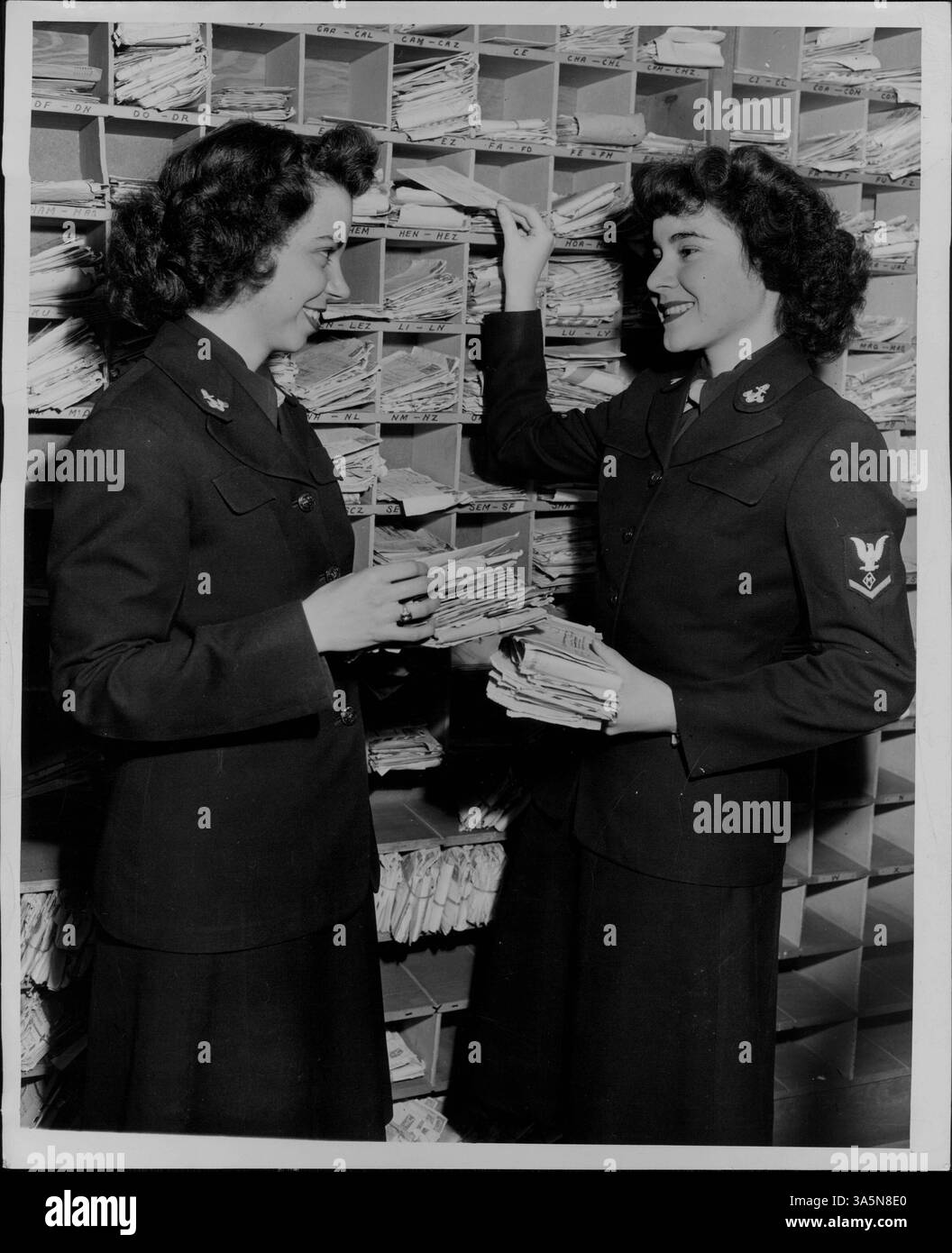 The photograph shows two female WAVE mailmen, Elizabeth J. 'Sunny ...