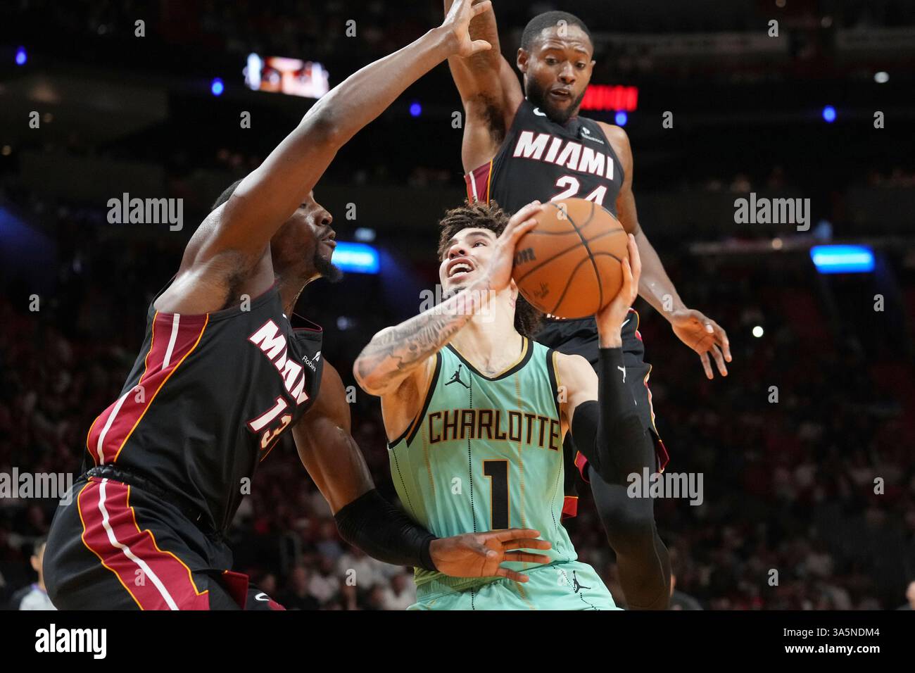 Miami Heat center Bam Adebayo (13) and forward Haywood Highsmith (24) defend Charlotte Hornets ...