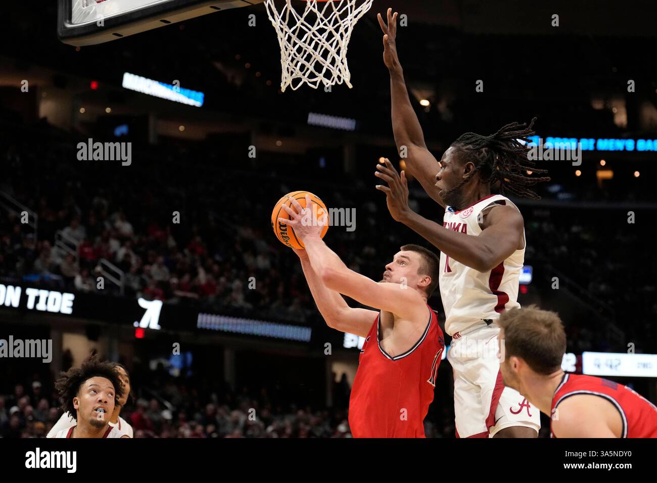 Saint Mary's center Mitchell Saxen goes to the basket in front of Saint ...