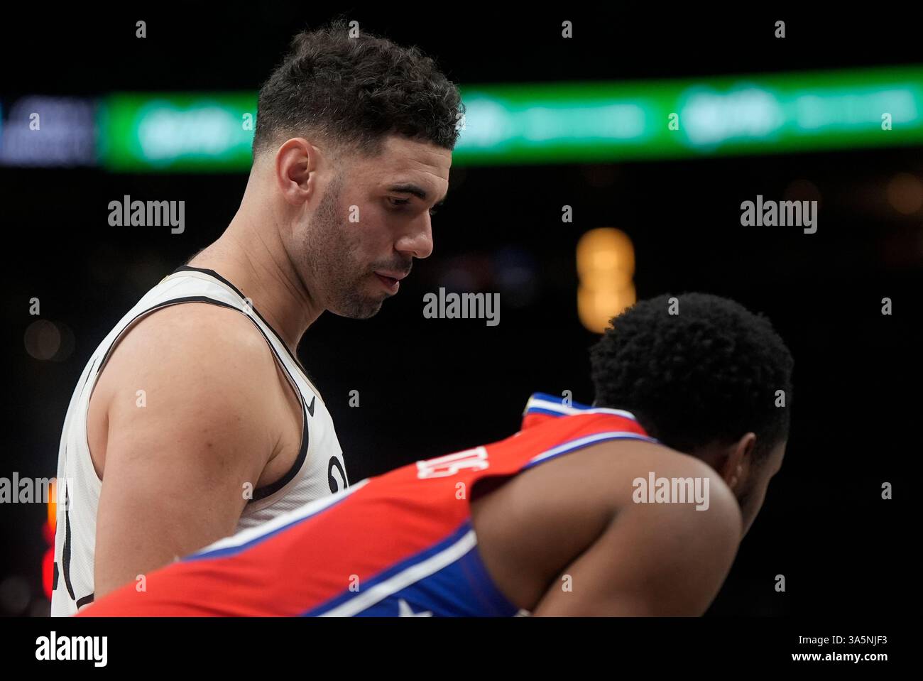 Atlanta Hawks forward Georges Niang (20) speaks with Philadelphia 76ers forward Guerschon ...