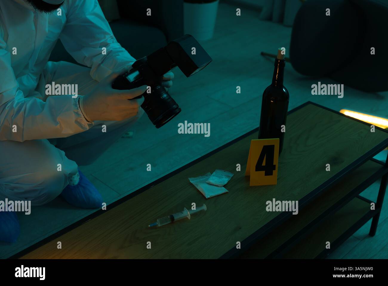 Forensic expert with camera taking photo of evidences at crime scene ...