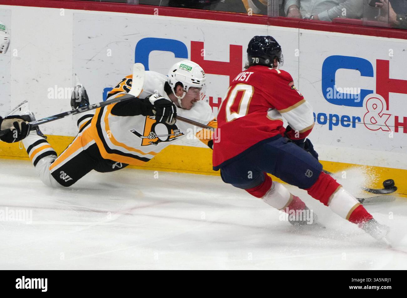 Pittsburgh Penguins center Connor Dewar, left, reaches for the puck as ...