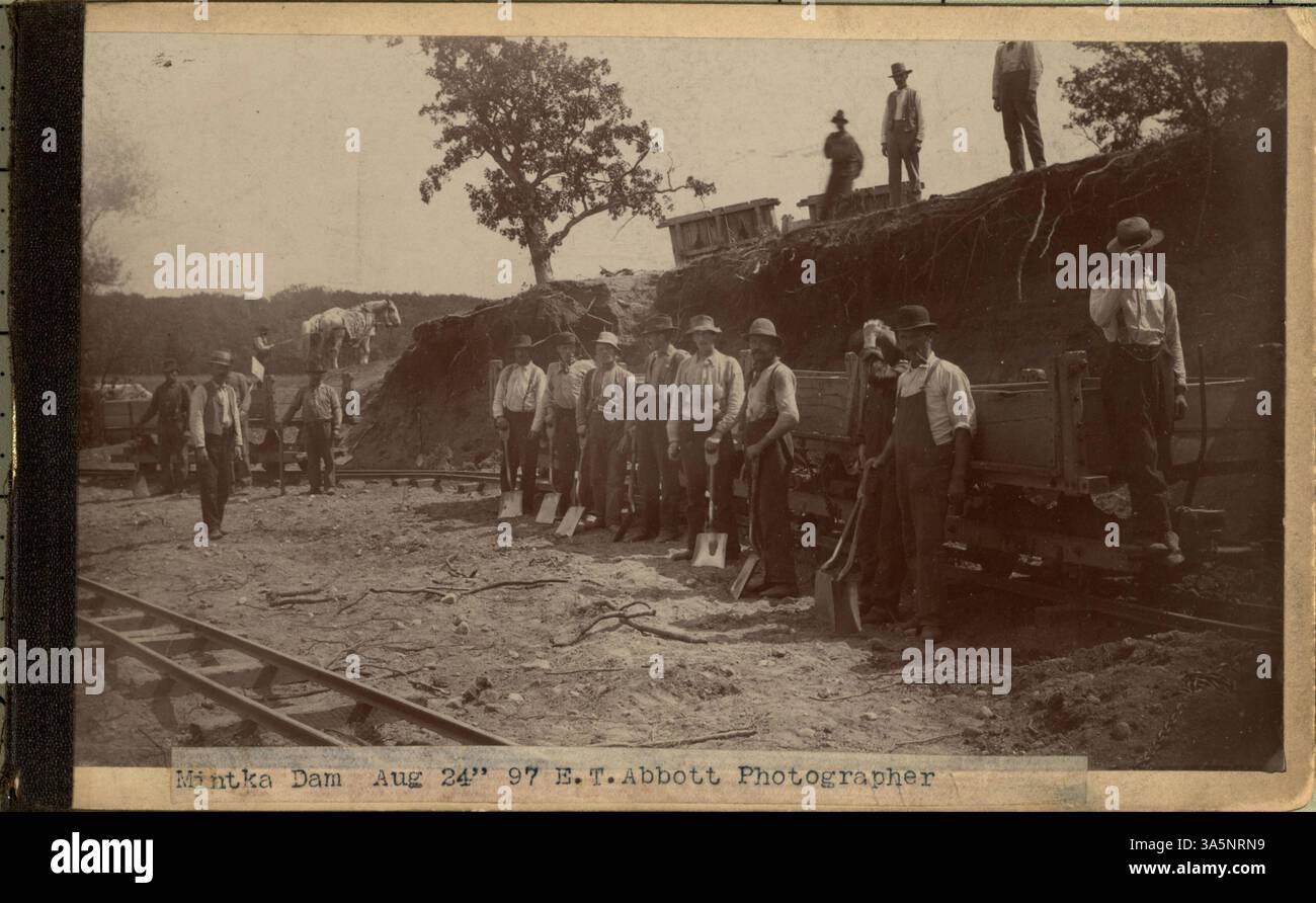 This historical image shows workers at the Gray's Bay Dam construction ...
