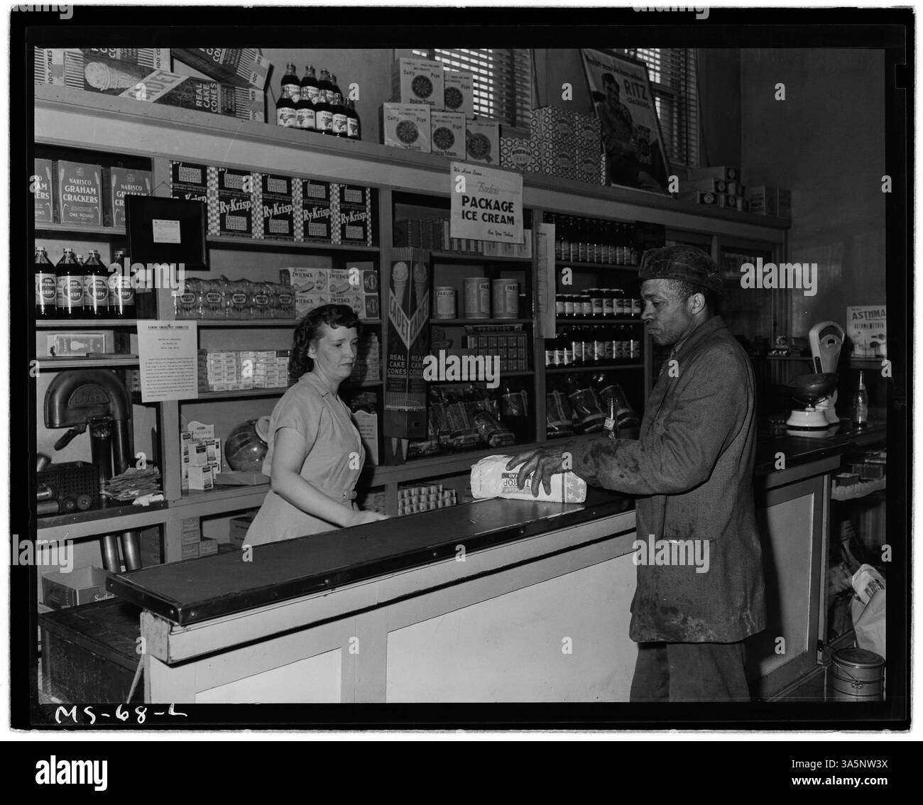 Miner Robert Rose buys a loaf of bread at the company store of H.C ...