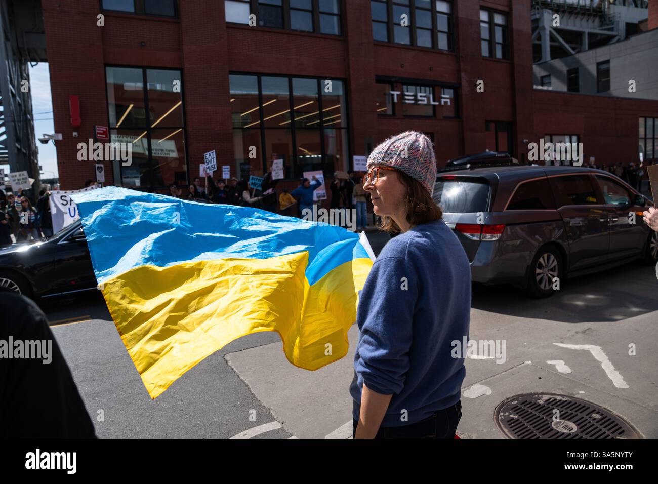 Mar 22, 2025; Brooklyn, NY, USA; A protestor waves a Ukrainian flag ...