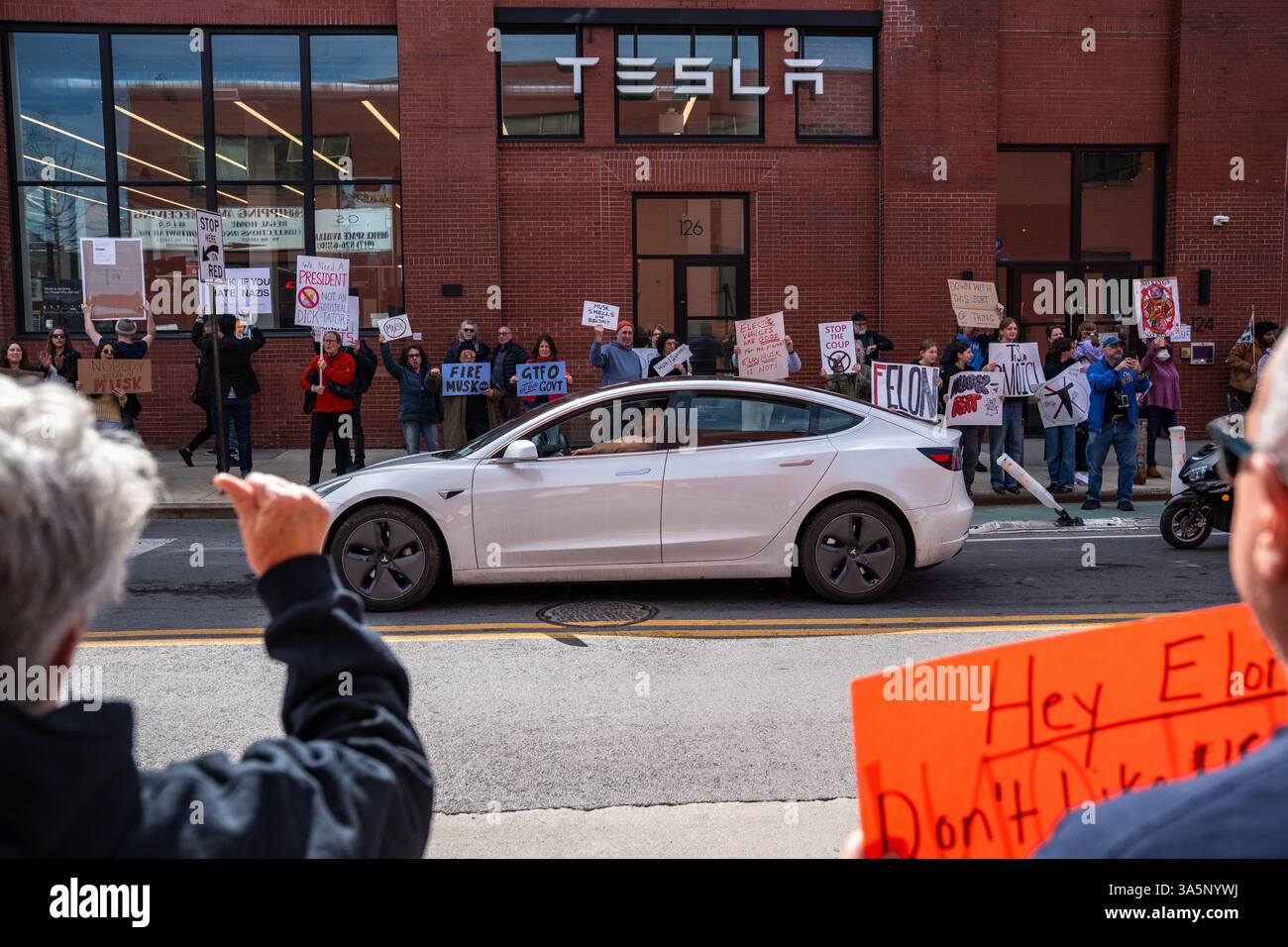 Mar 22, 2025; Brooklyn, NY, USA; A passing driver in a Tesla pleads ...