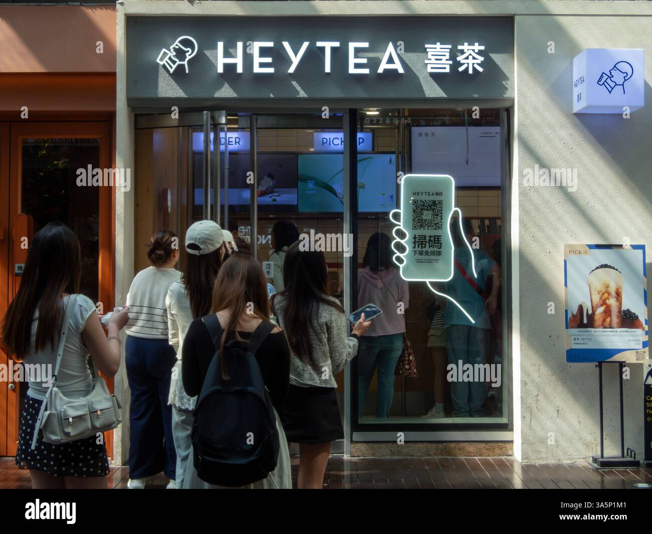 Hong Kong, China. 23rd Mar, 2025. Customers seen lining up to buy drinks at the HEYTEA store in ...