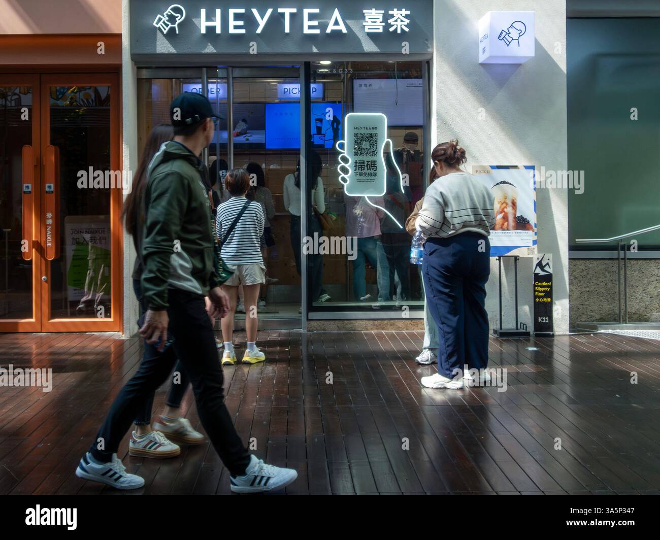 Hong Kong, China. 23rd Mar, 2025. People seen walking past the HEYTEA store in K11 Art Mall ...