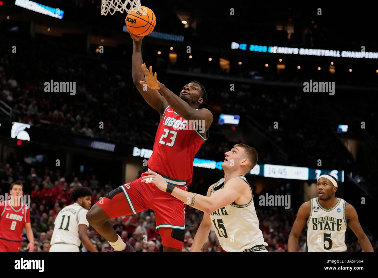 New Mexico center Nelly Junior Joseph (23) shoots in front of Michigan ...