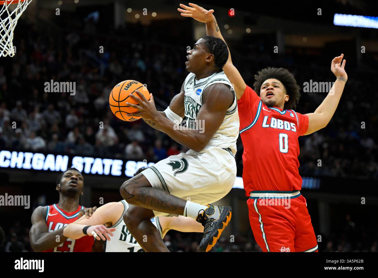 Michigan State forward Coen Carr (55) drives to the basket beside New ...