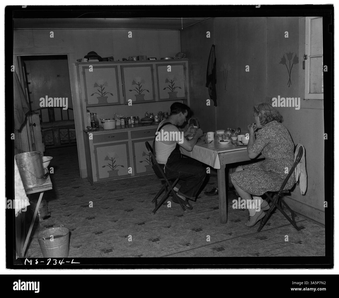 Fred Nutter, a miner, and his wife have lunch in the kitchen of their ...