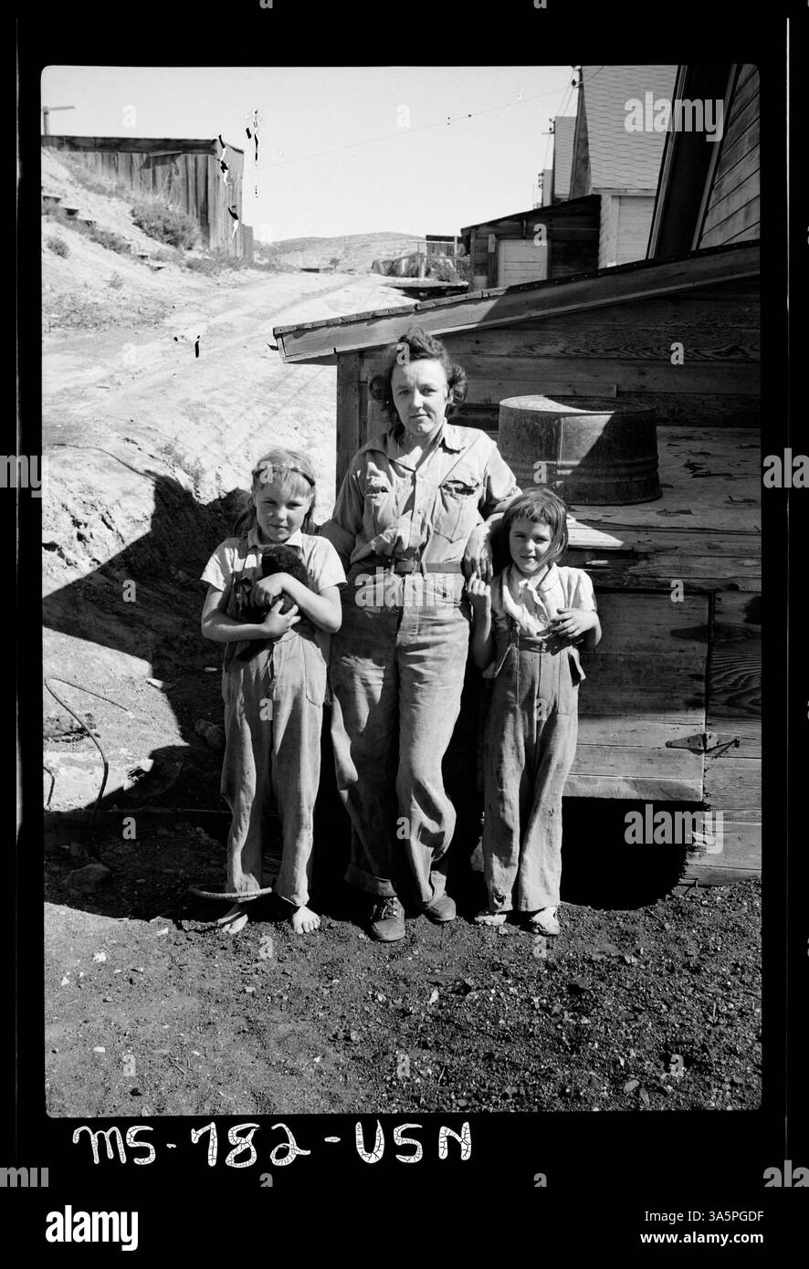 A mother and two of her six children are pictured in a mining camp near ...