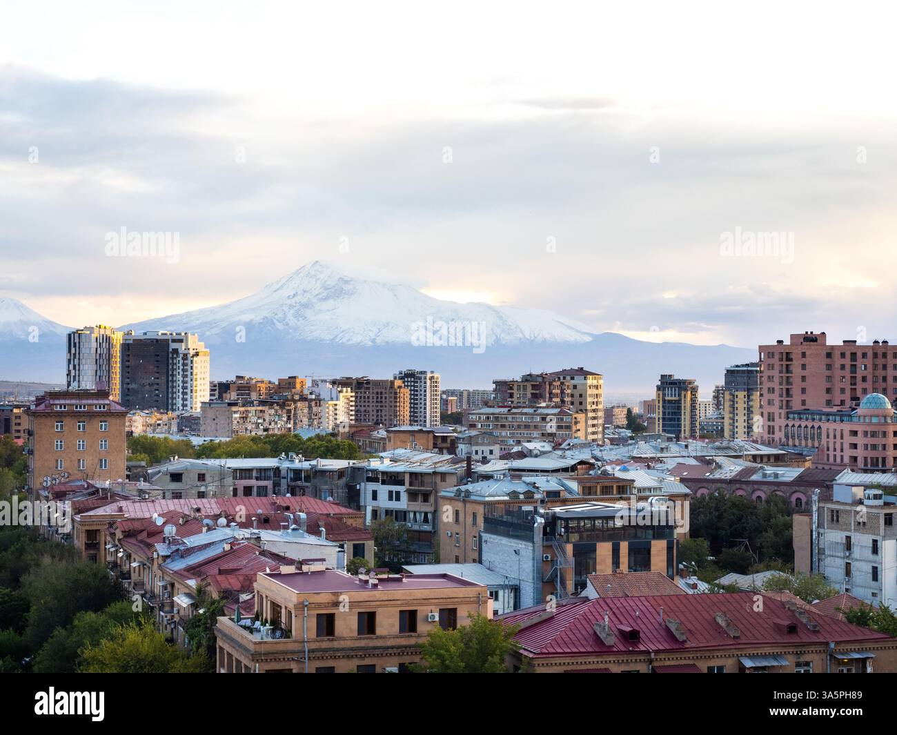 Scene of Yerevan cityscape with buildings and trees, with Mount Ararat ...