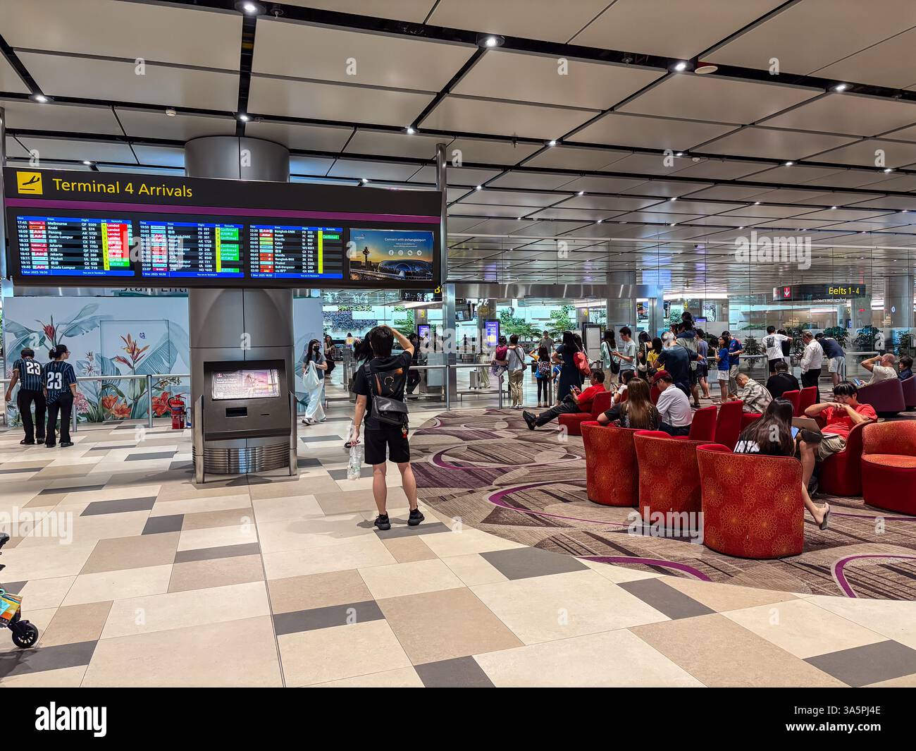 Interior of Changi International Airport showing the arrivals board and ...