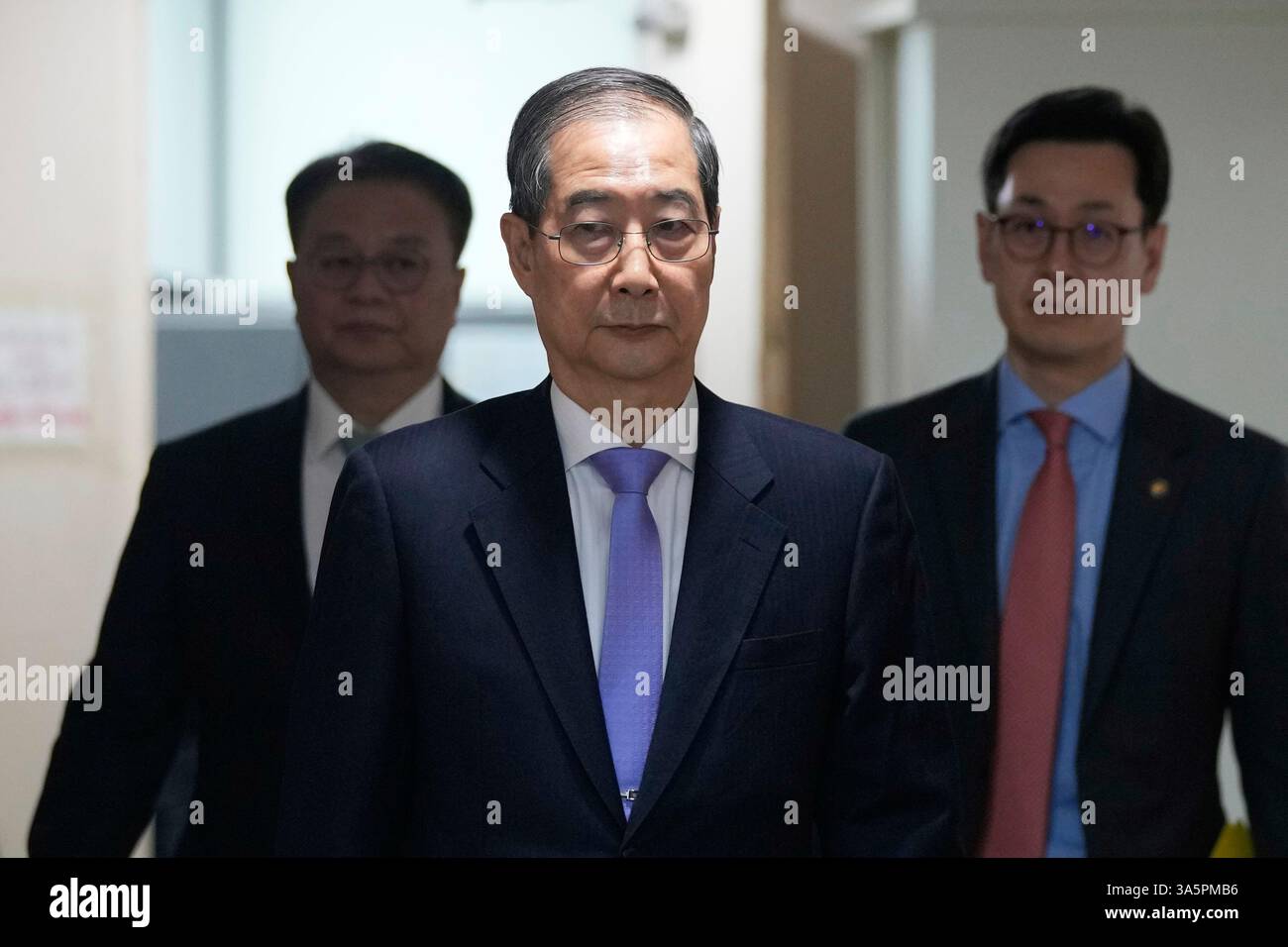 South Korean acting President Han Duck-soo, center, arrives to hold a ...