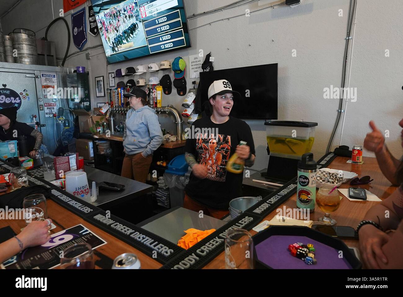 Owners Miranda Spencer, front, and Annie Weaver work behind the bar in ...