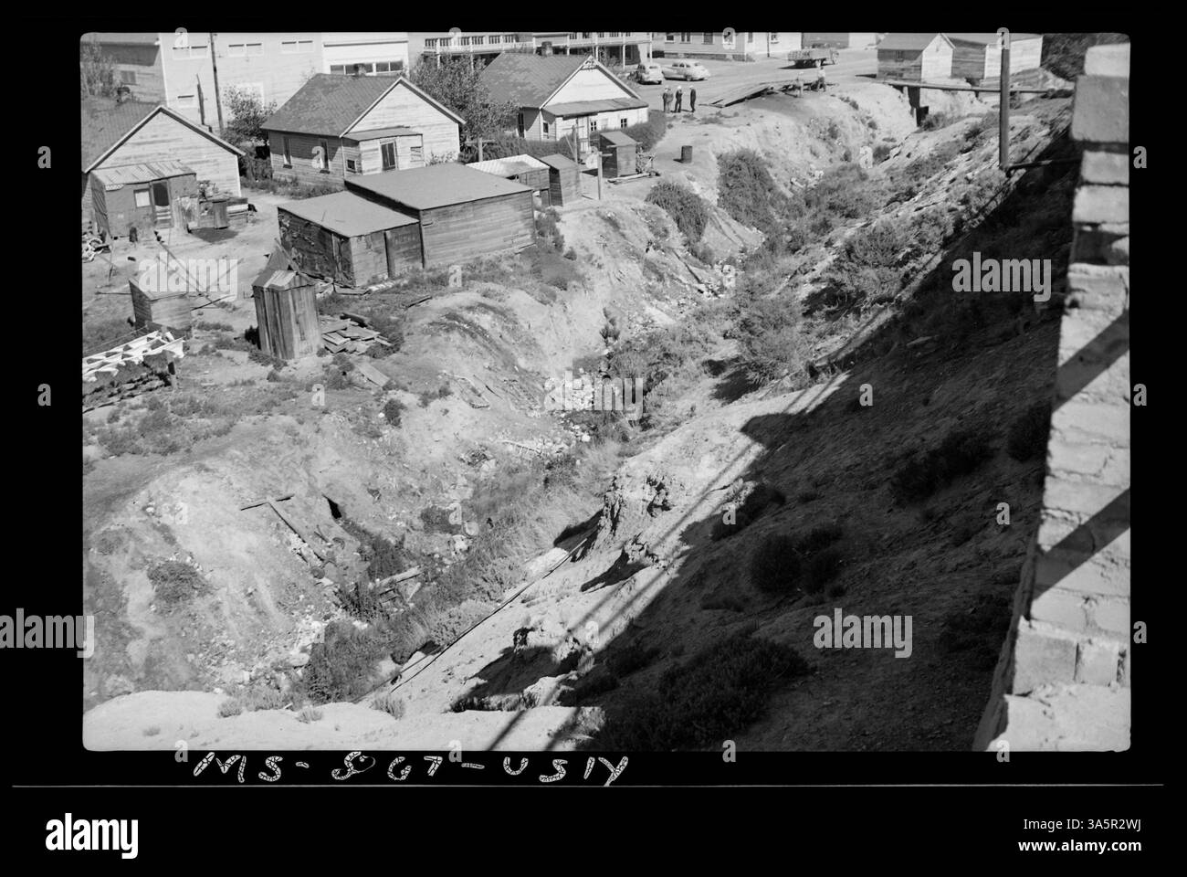 A photograph depicting a mining community, showing typical housing and ...