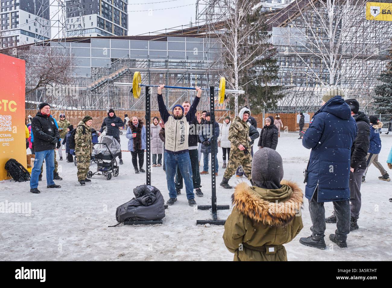 Yekaterinburg, Russia - March 2, 2025: Man lifts barbell during outdoor ...