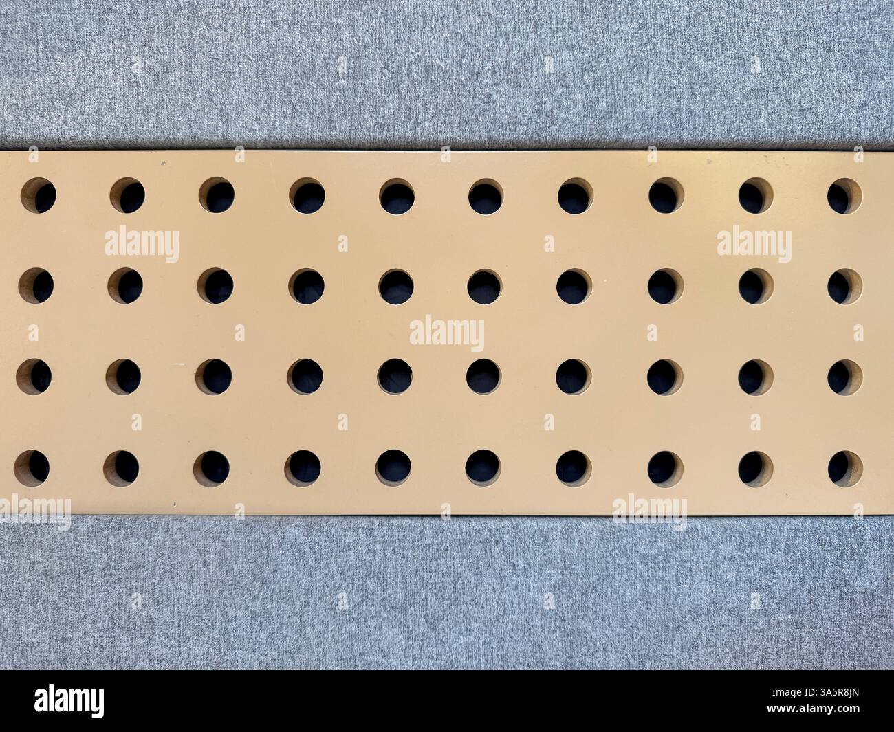 Series of grey upholstered panel with horizontal gold metal plate. This ...